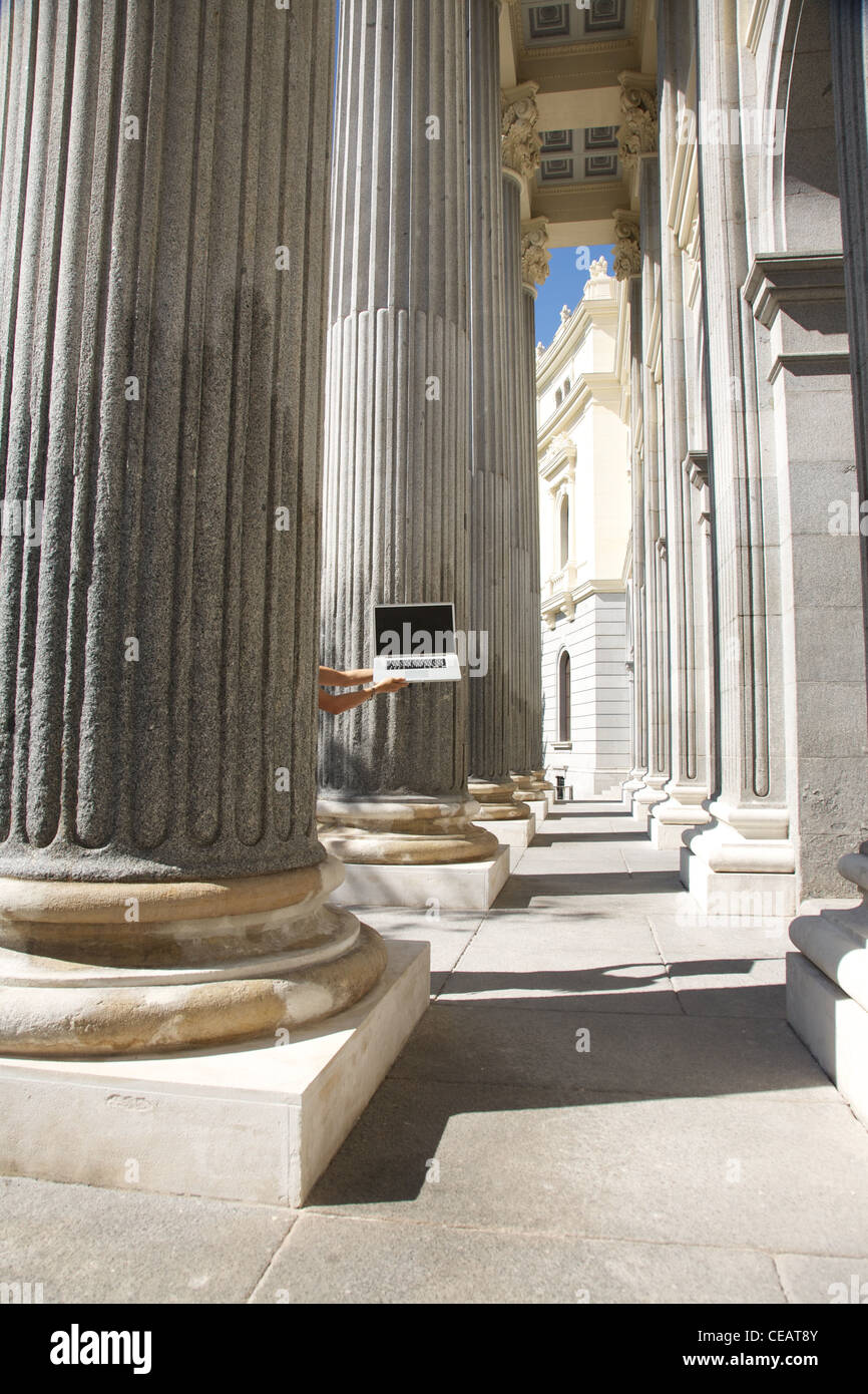 business woman between big columns in Madrid city Spain Stock Photo - Alamy