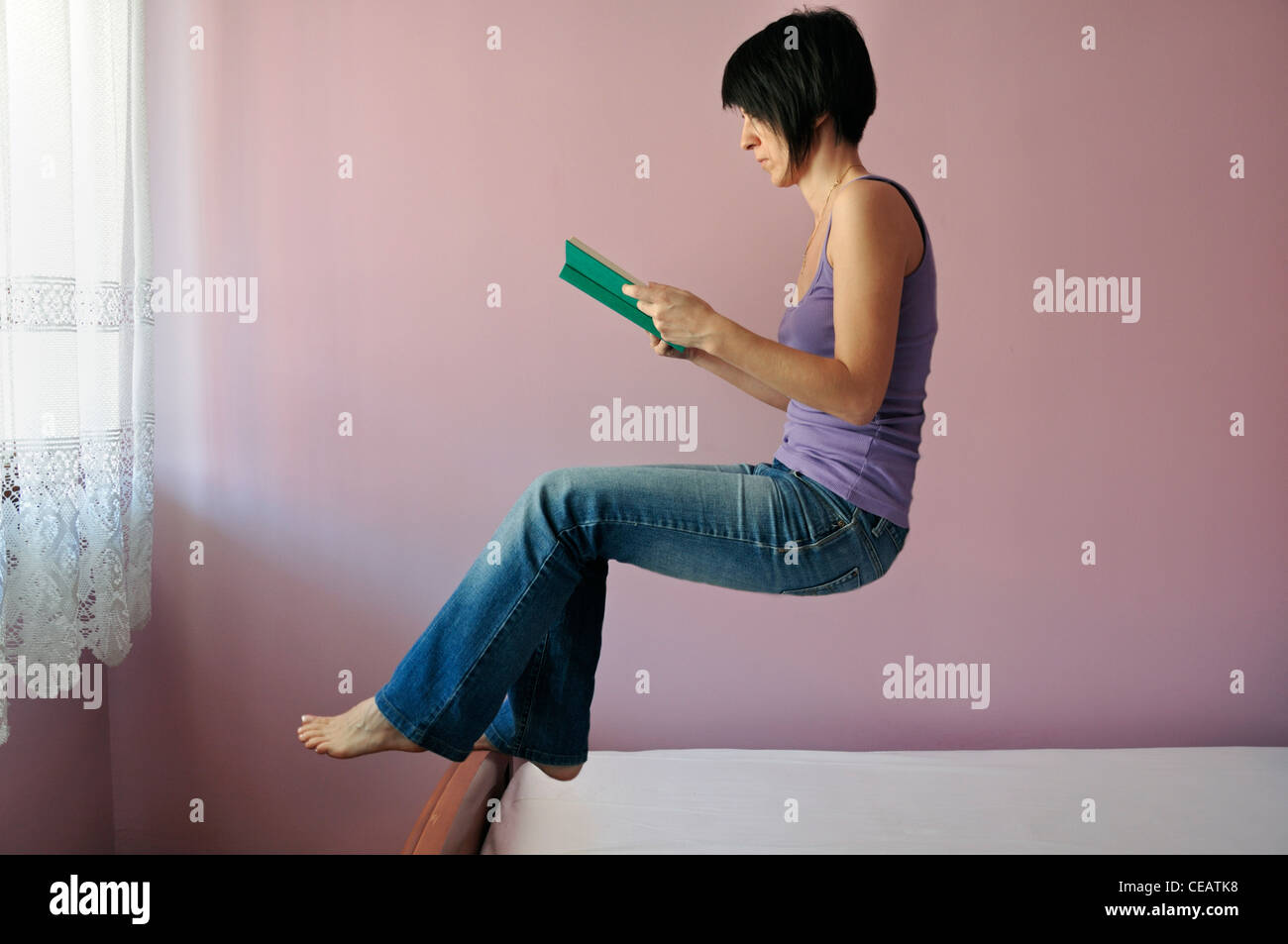 Woman floating reading book Stock Photo - Alamy