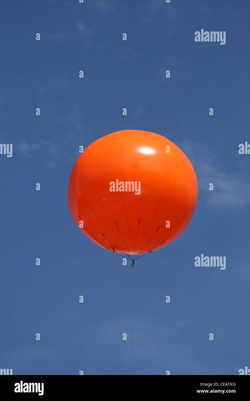 orange baloon floating against blue sky Stock Photo - Alamy