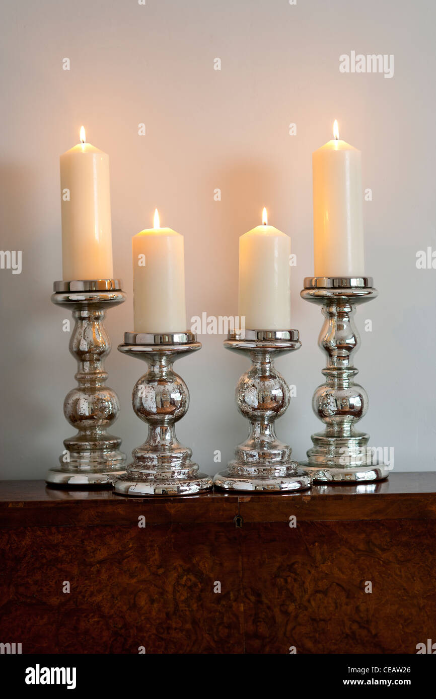 4 Candles on candlesticks Stock Photo - Alamy