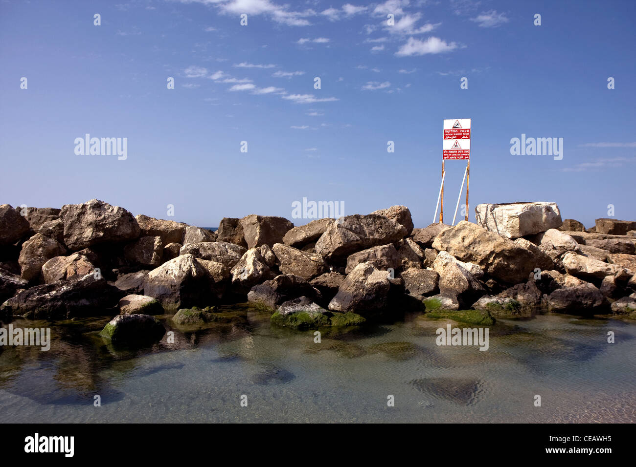 Caution slippery rocks sign in beach of Tel Aviv Stock Photo - Alamy