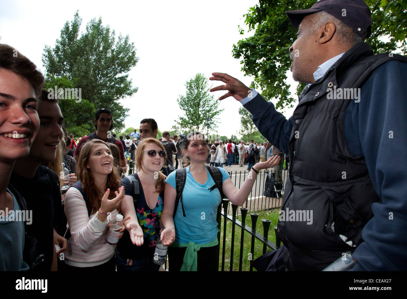 Girls arguing with a speaker at Speakers' Corner, an area where public ...