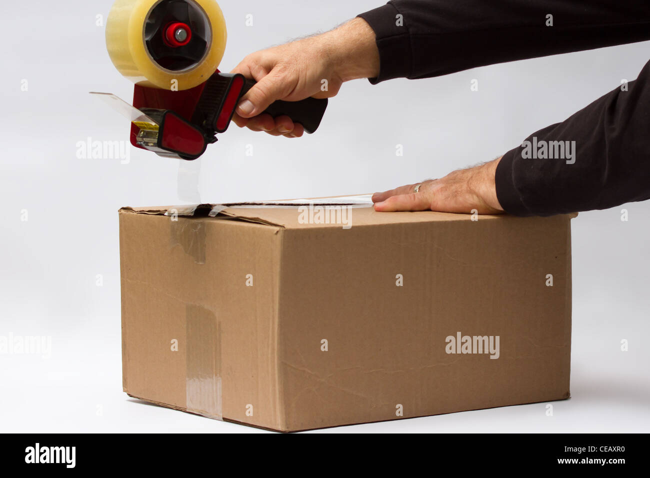 Man preparing a box for safe shipping Stock Photo - Alamy