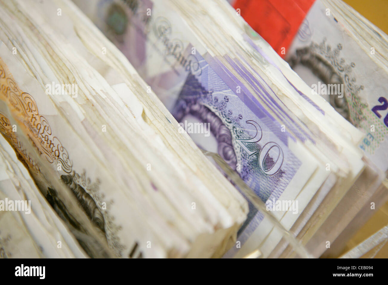 Ten and twenty pound notes in container Stock Photo - Alamy