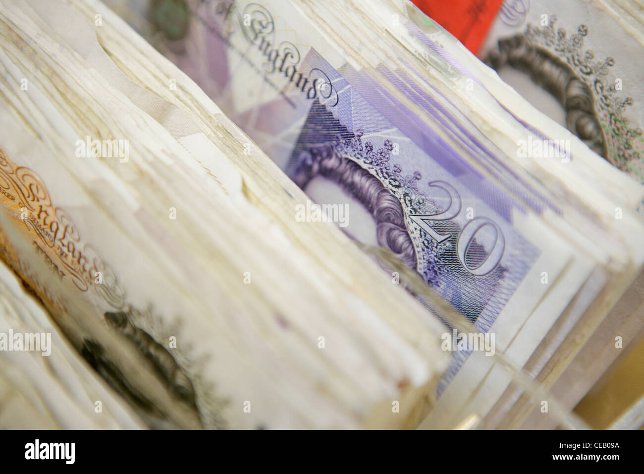 Ten and twenty pound notes in container Stock Photo - Alamy