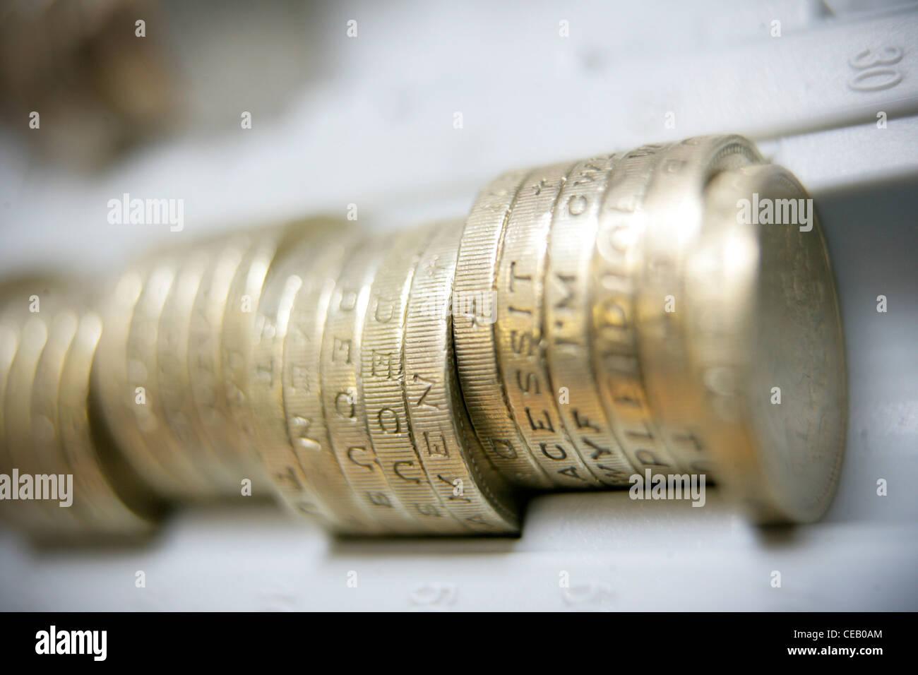 A stack of one pound coins in a container Stock Photo - Alamy
