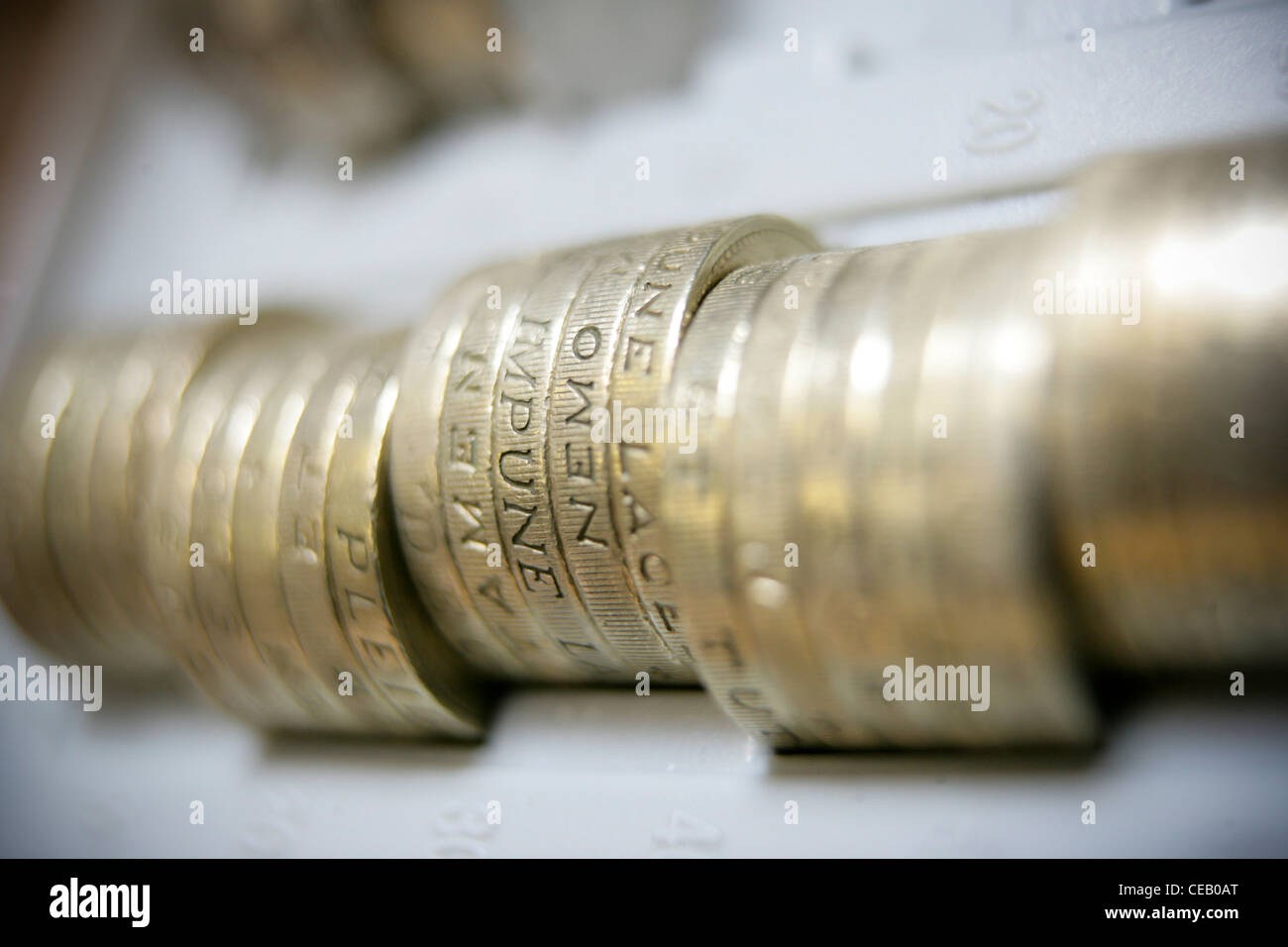 A stack of one pound coins in a container Stock Photo - Alamy