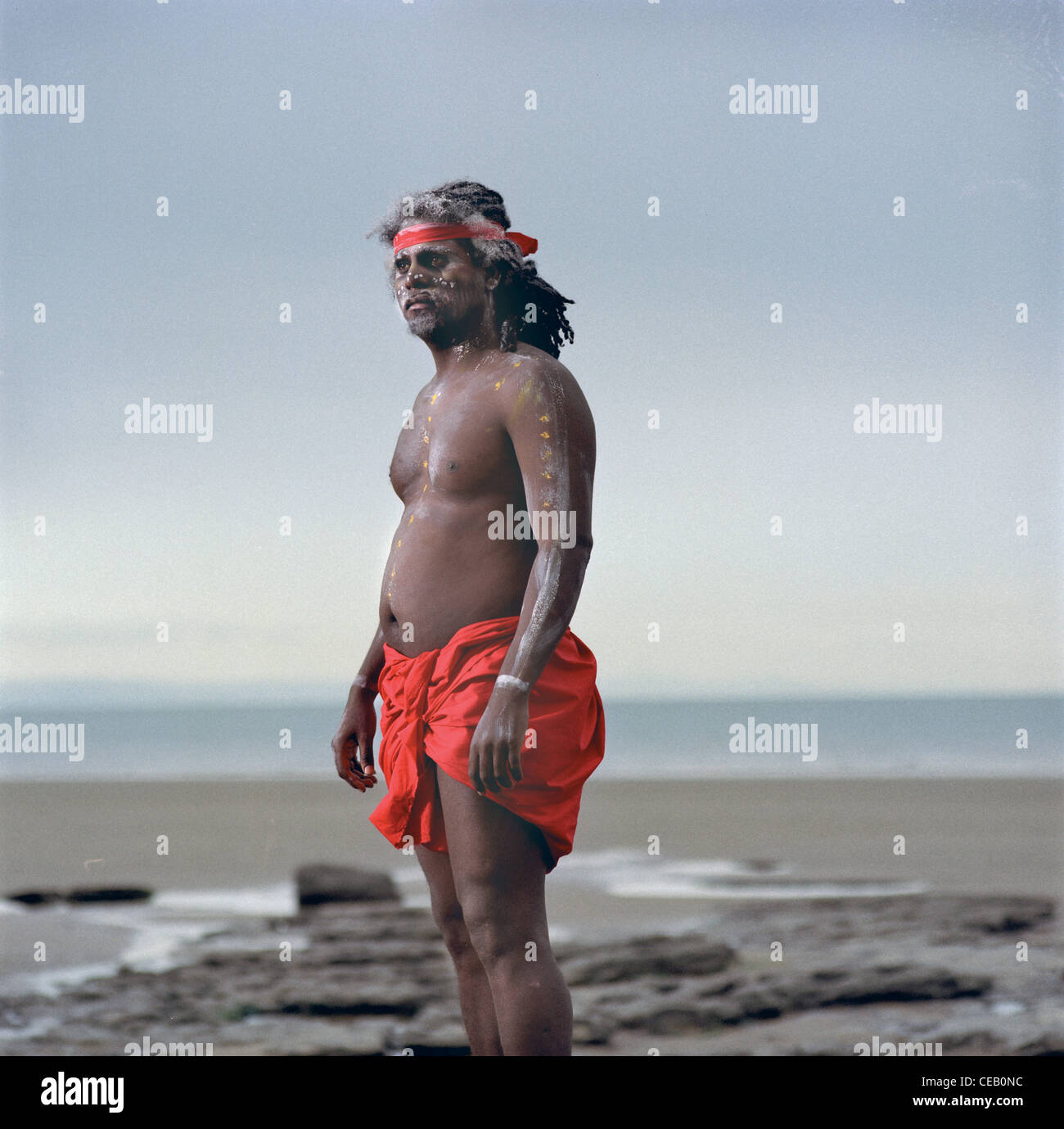 Aboriginal man playing a didgeridoo on a beach Stock Photo - Alamy