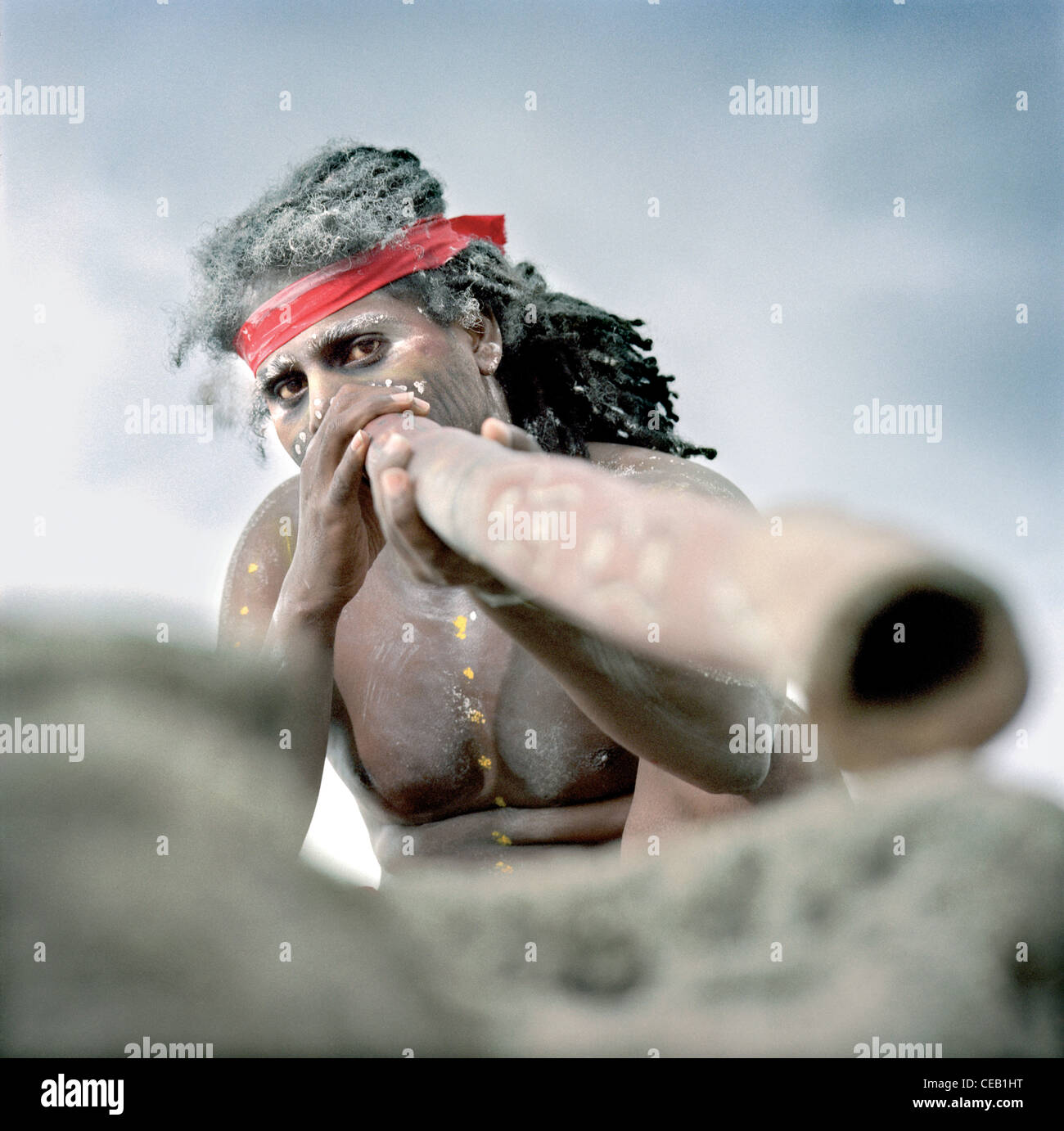 Aboriginal man playing a didgeridoo on a beach Stock Photo - Alamy
