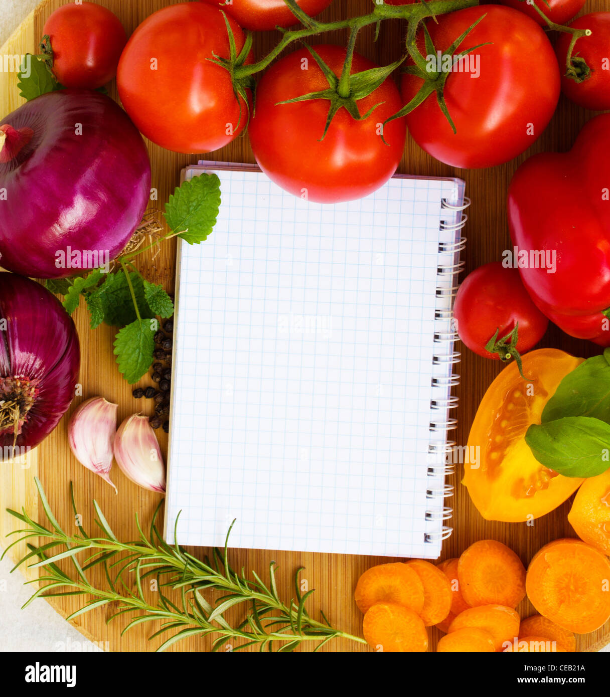 blank notebook on wooden desk and frame of colorful vegetables Stock ...