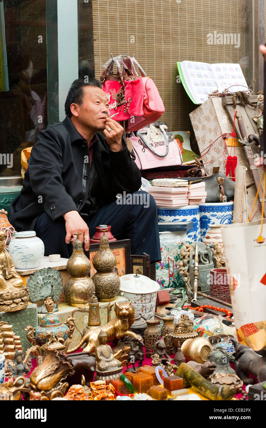 Salesman smoking, crafts shop, Panjiayuan flea market, Chaoyang ...