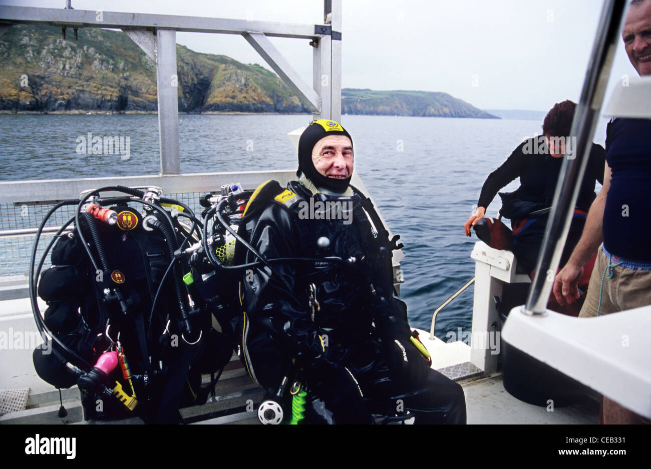 Scuba diver rests after completing his dive. Off the coast of Cornwall ...