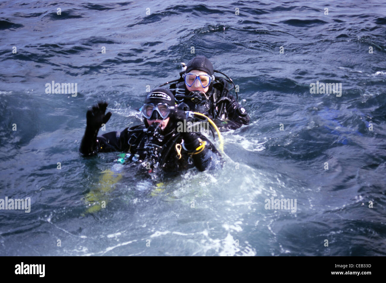 Scuba divers break the surface by the dive boat Wavedancer out of St ...