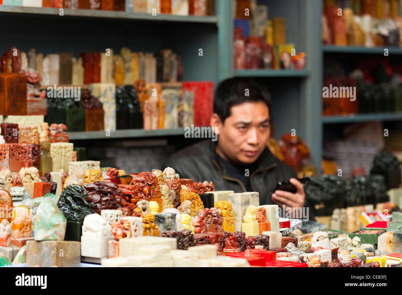 Stone carver, traditional chinese stamp shop, Panjiayuan flea market, Chaoyang District, Beijing ...