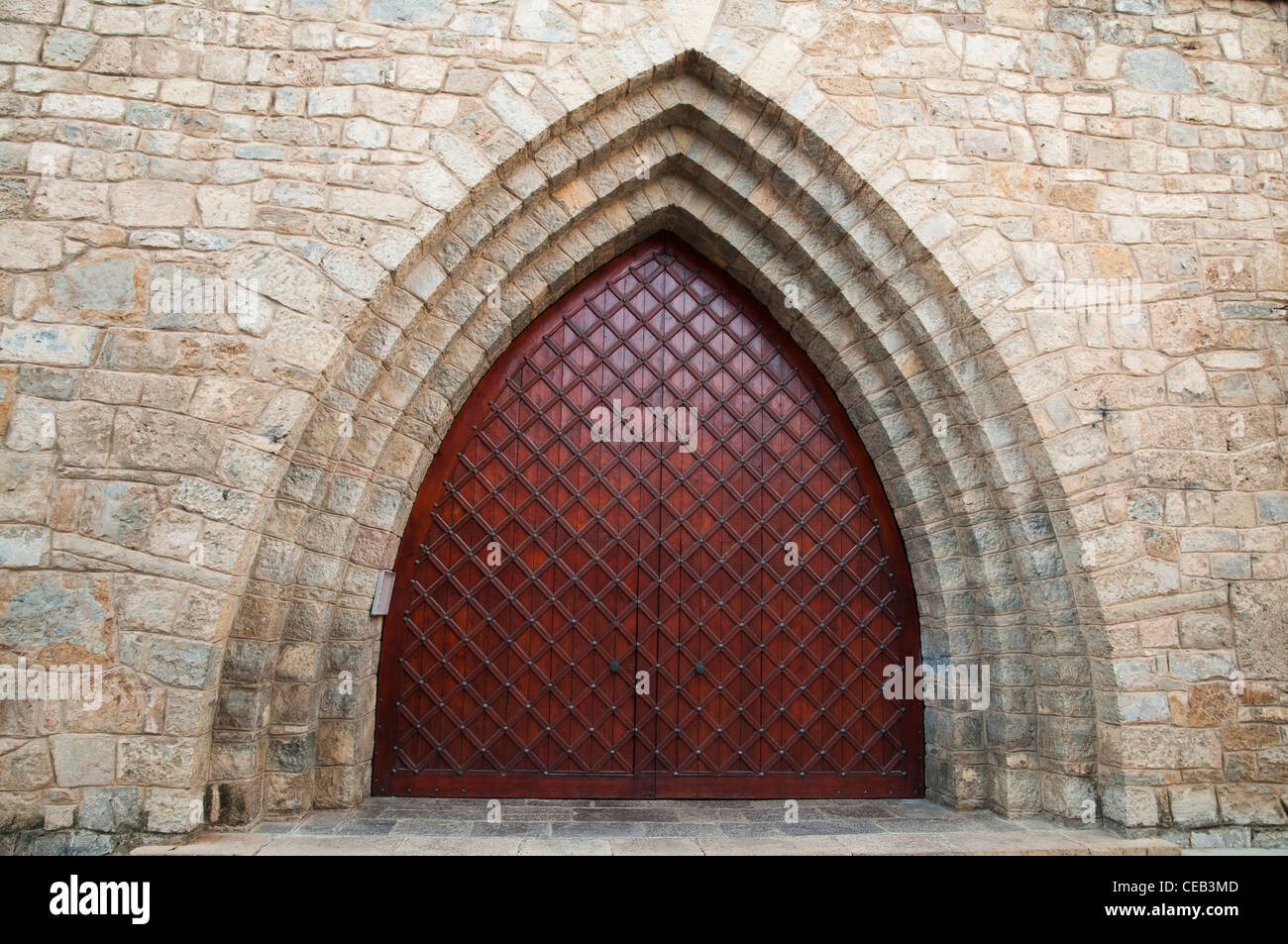 Main entrance and wooden door of the church of Isona, Lleida, Spain ...