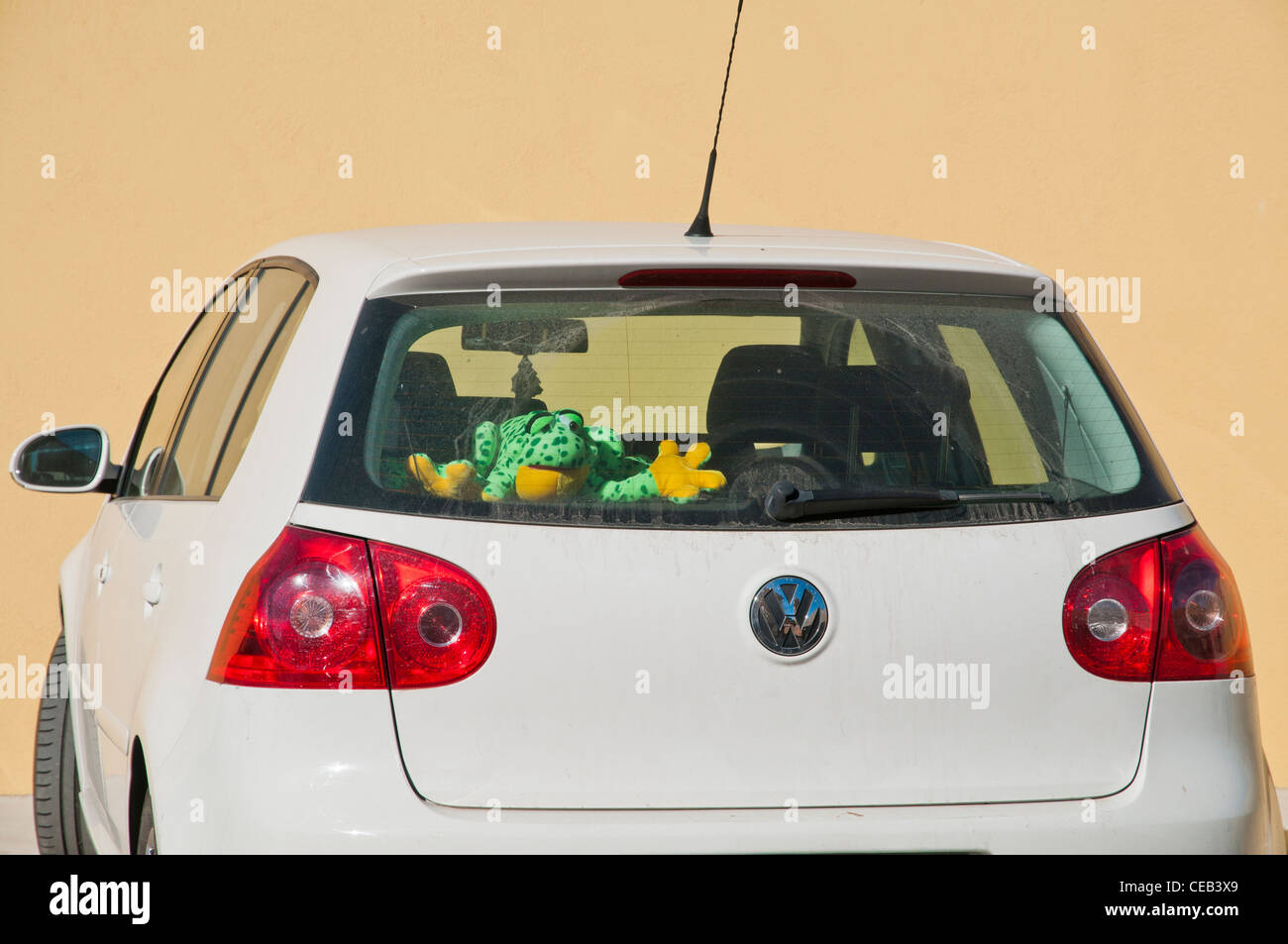 Frog flurry puppet left inside a white car parked in the sun Stock ...