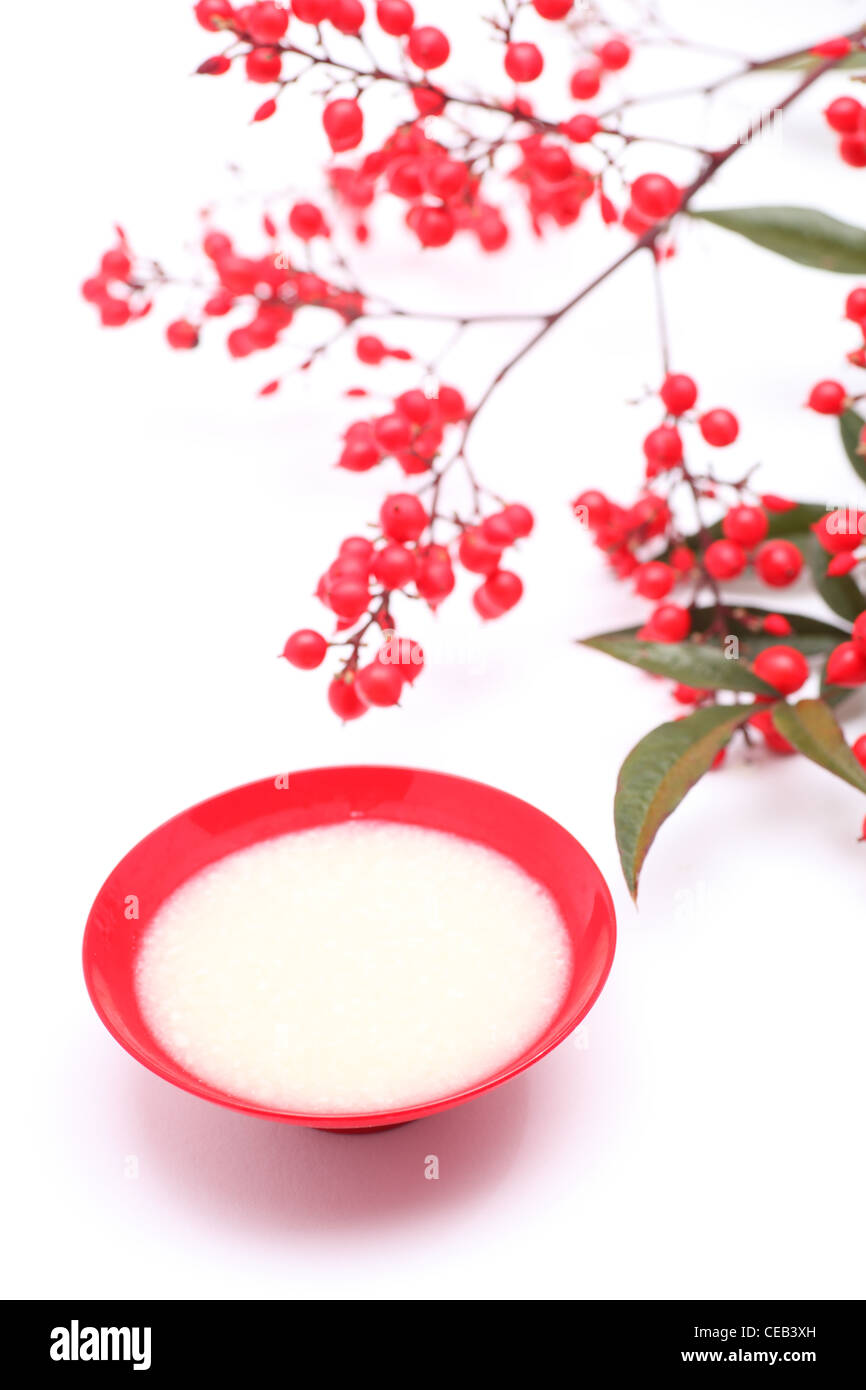 Japanese sweet mild sake and nandina domestica Stock Photo - Alamy