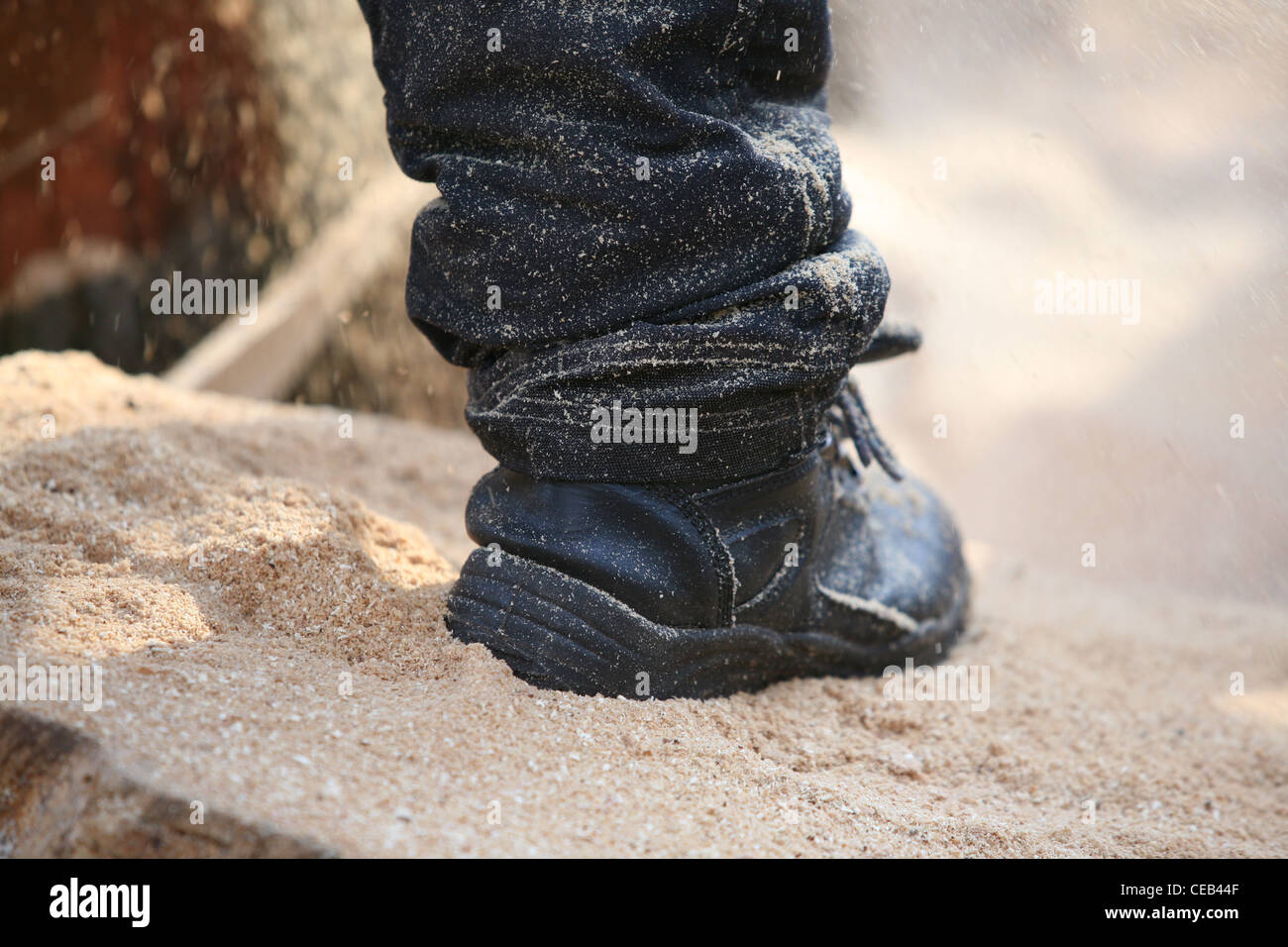 a carpenters foot surrounded by sawdust Stock Photo - Alamy