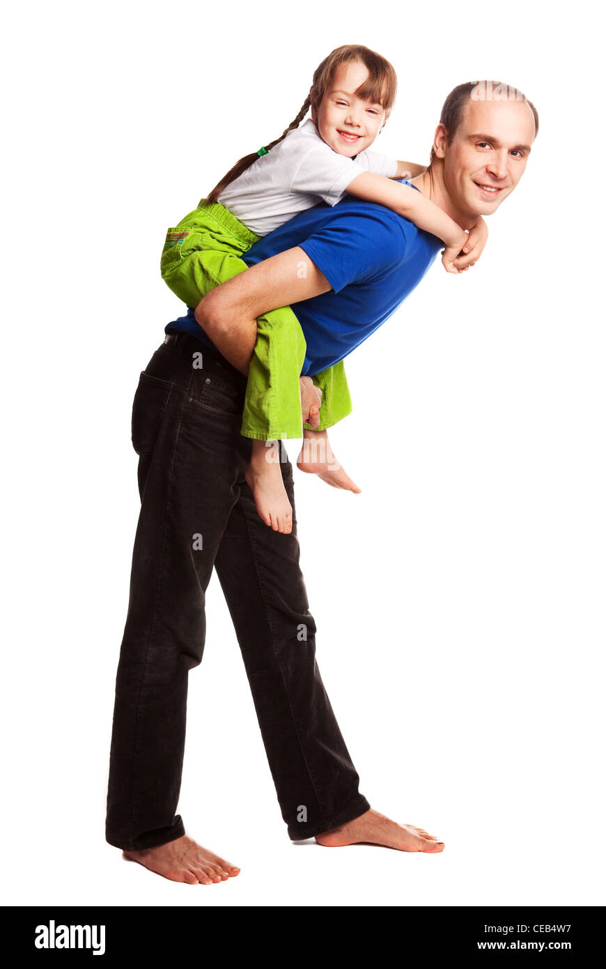 happy family; young father giving a piggyback ride to his daughter ...