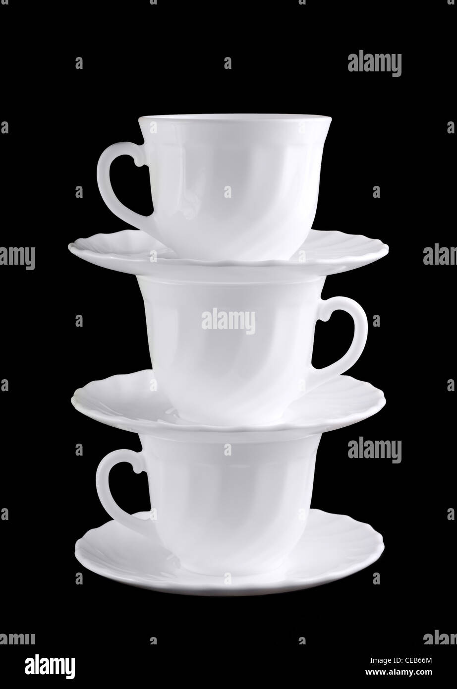 Pile of white cups isolated at the dark background Stock Photo - Alamy