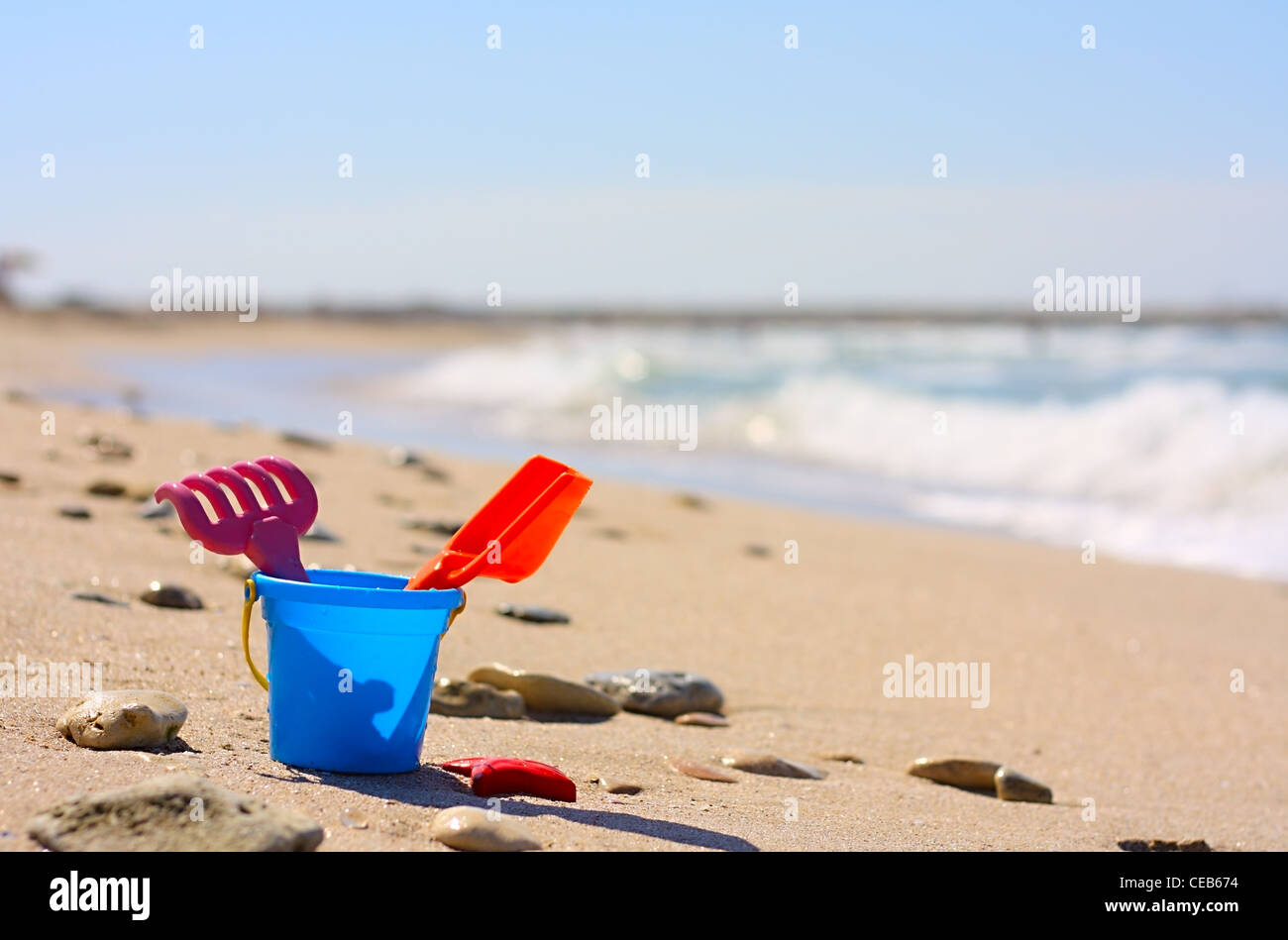 Plastic bucket on the beach near the sea Stock Photo - Alamy