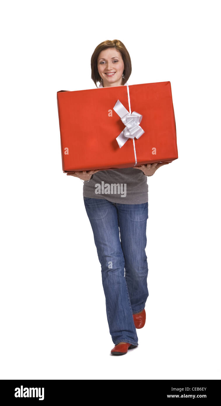 Young woman carrying a big red gift box Stock Photo - Alamy