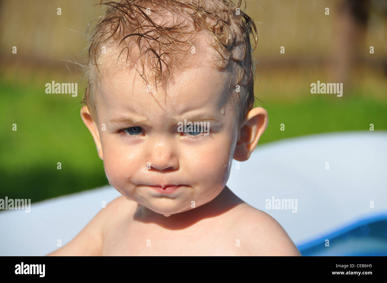 wet little boy with anger on his face Stock Photo - Alamy