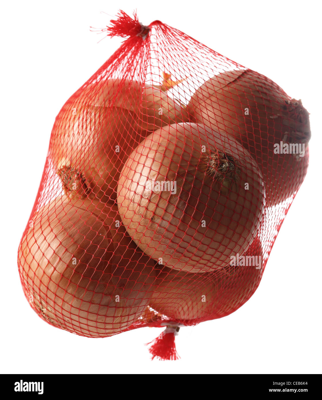Onions in net against a white background Stock Photo - Alamy