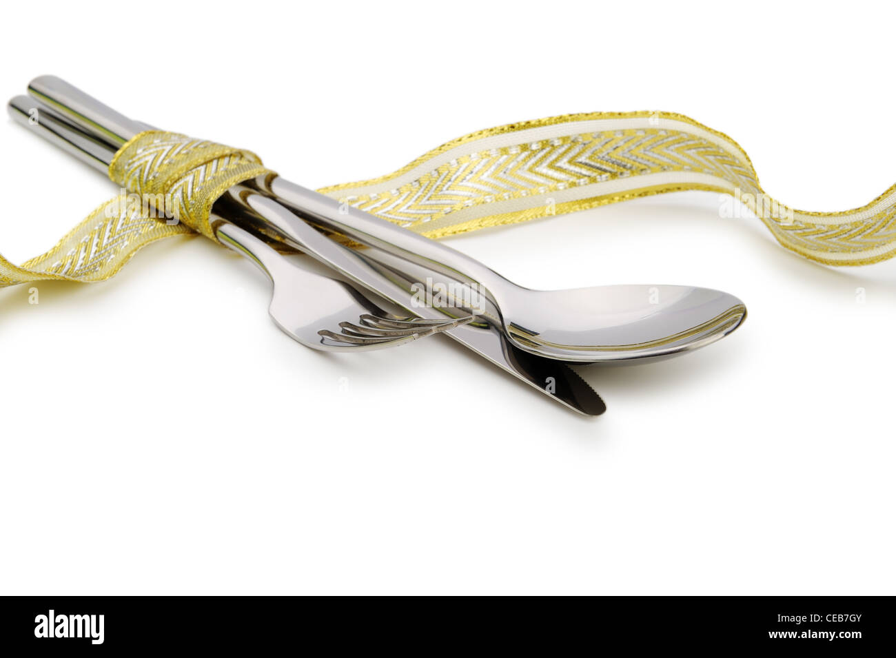 Spoon, fork and a knife tied up celebratory ribbon. It is isolated on a ...