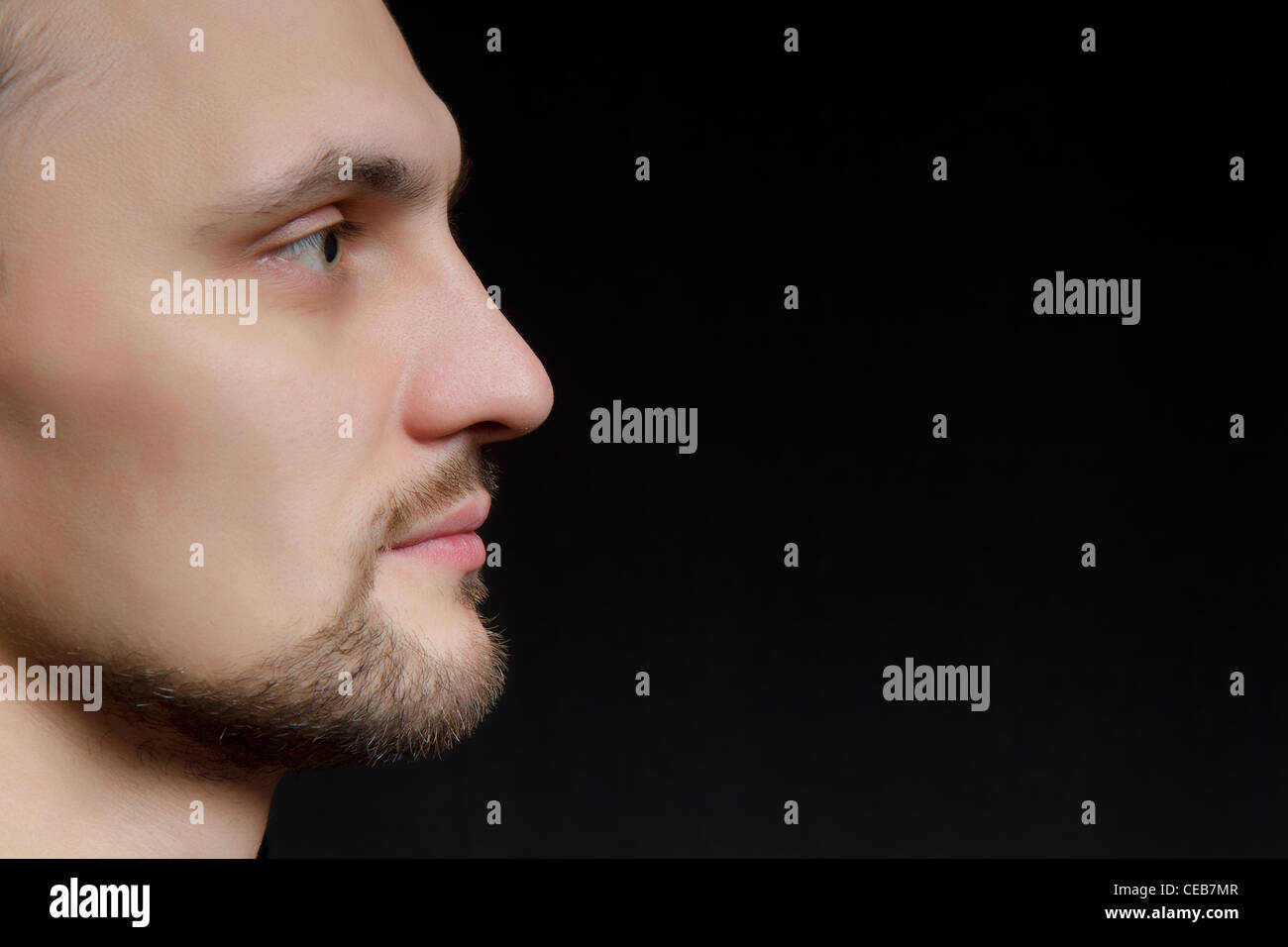 face of the young unshaven man in a black background Stock Photo - Alamy