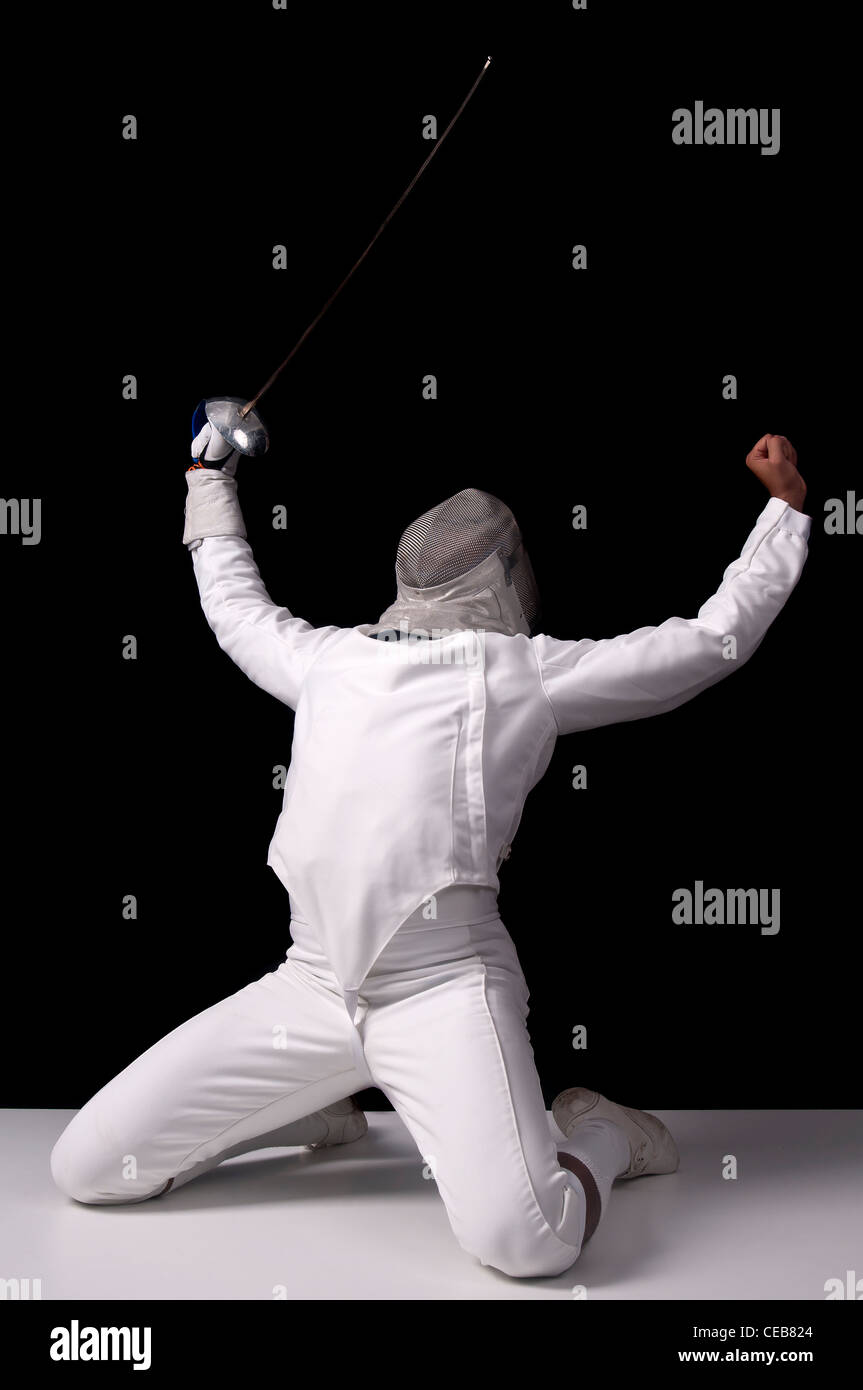 Male fencer isolated in a dark background Stock Photo - Alamy