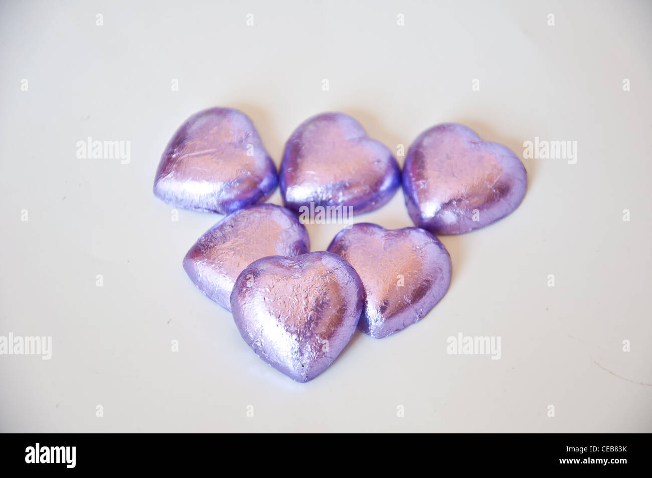 violet chocolate love on white background Stock Photo - Alamy