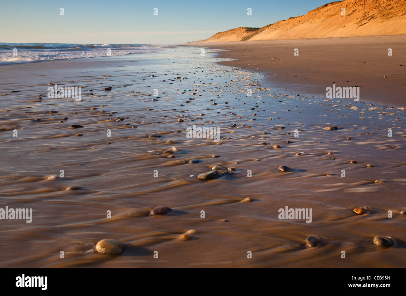 Low angle view of empty beach with beach rocks and cliff Stock Photo ...