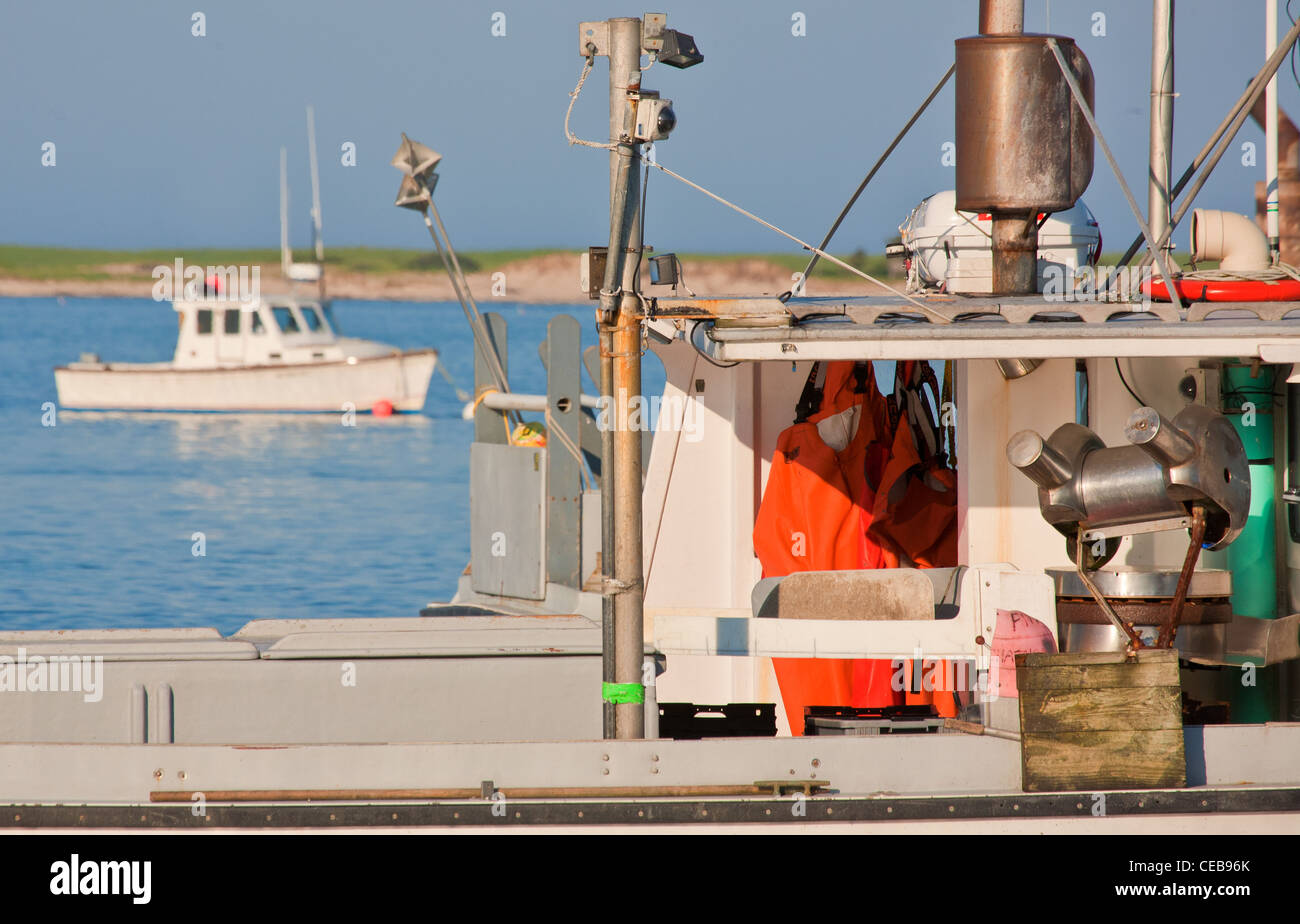 Close-up of deck and cabin of fishing boat with second boat in distance ...
