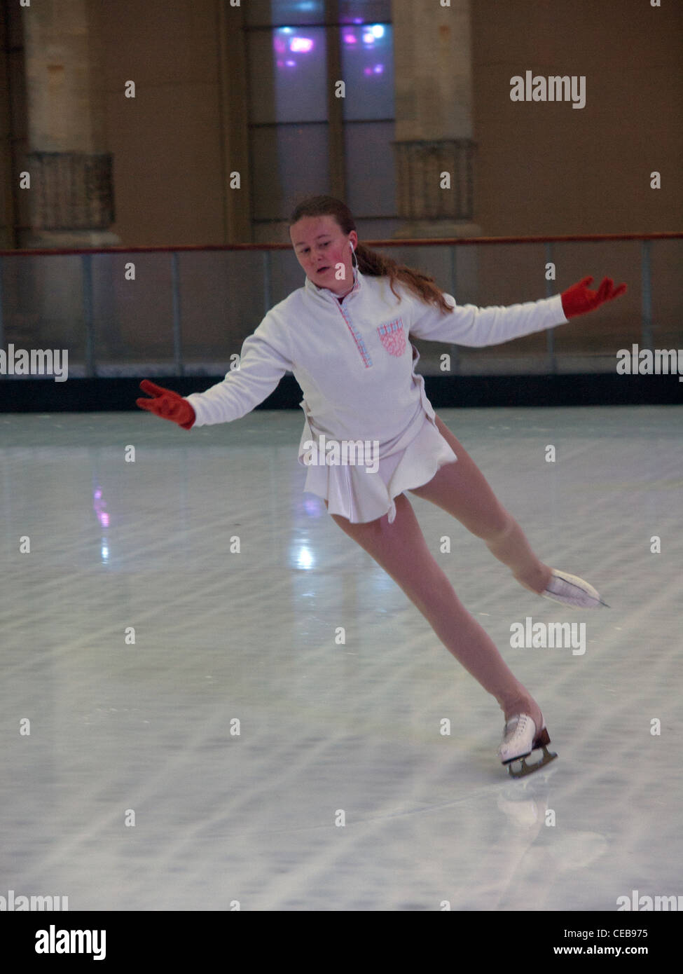 An ice-skater glides across the ice Stock Photo - Alamy