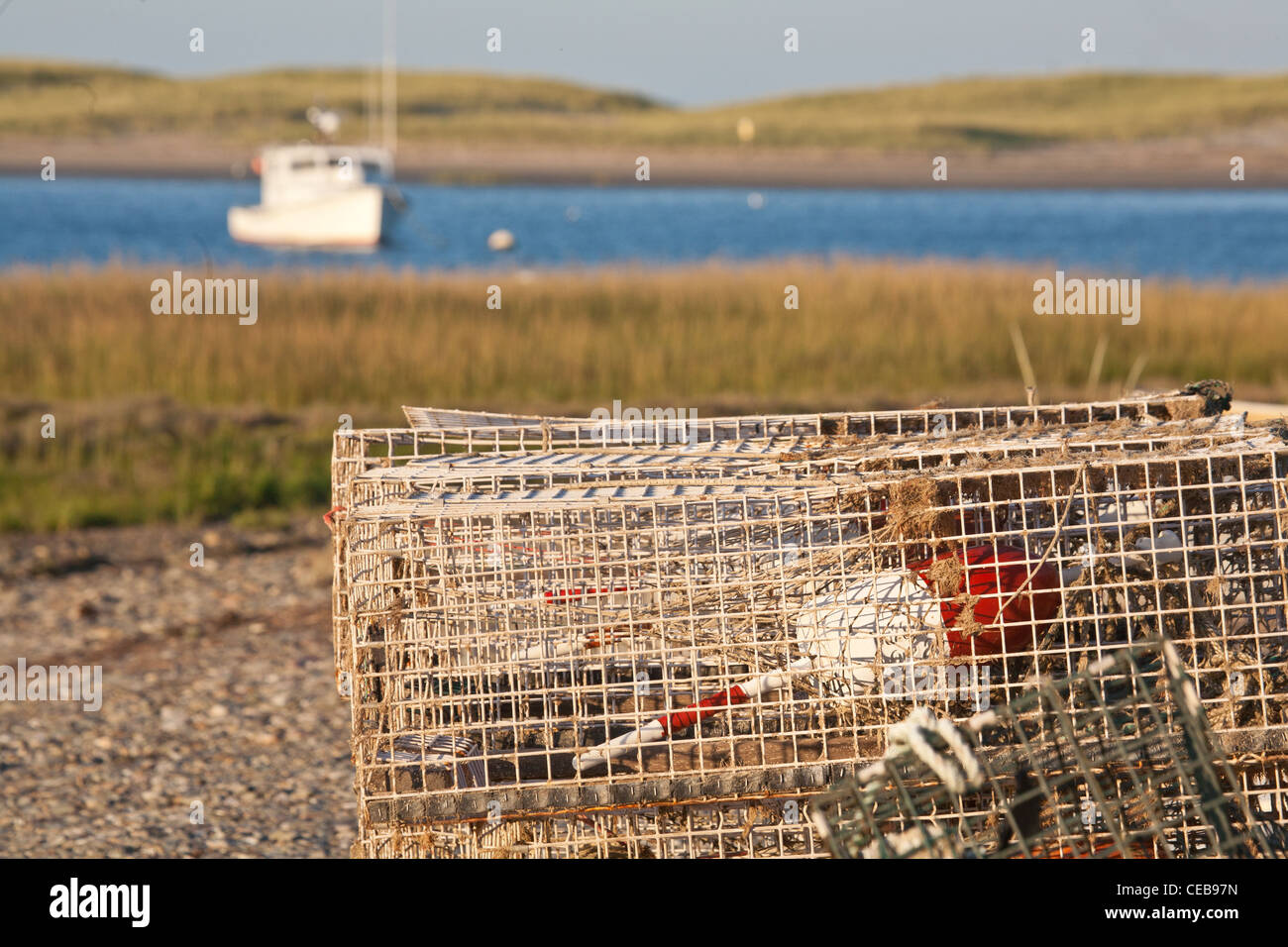 Lobster trap on shore with lobster boat pictured in distance Stock ...