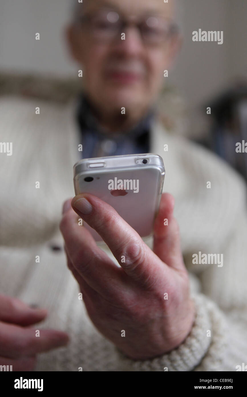 Old man using touchscreen smartphone hi-res stock photography and ...