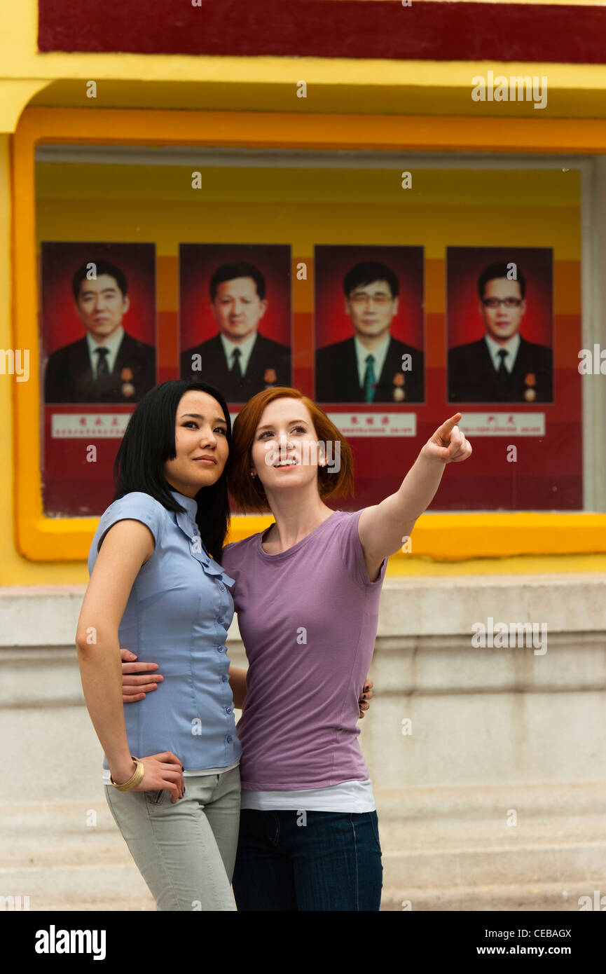 Tourist pointing something out to her friend in The Forbidden City ...