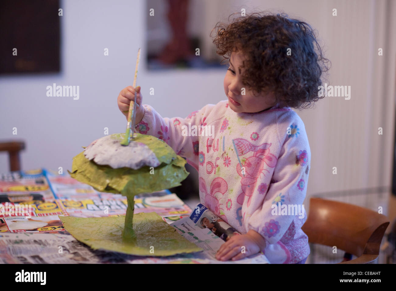 Child girl toddler making model tree painting Stock Photo - Alamy
