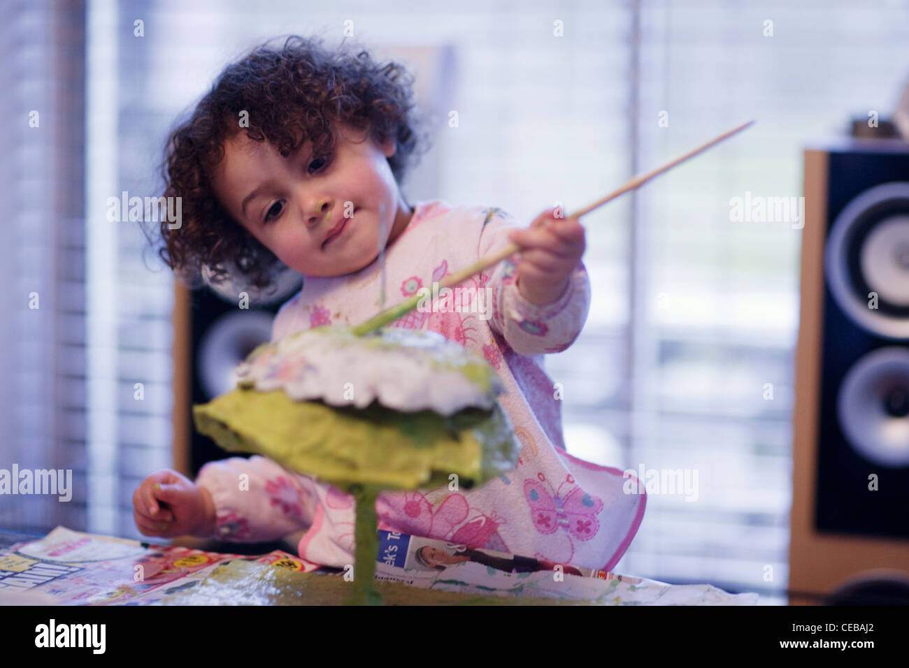 Child girl toddler making model tree painting Stock Photo - Alamy