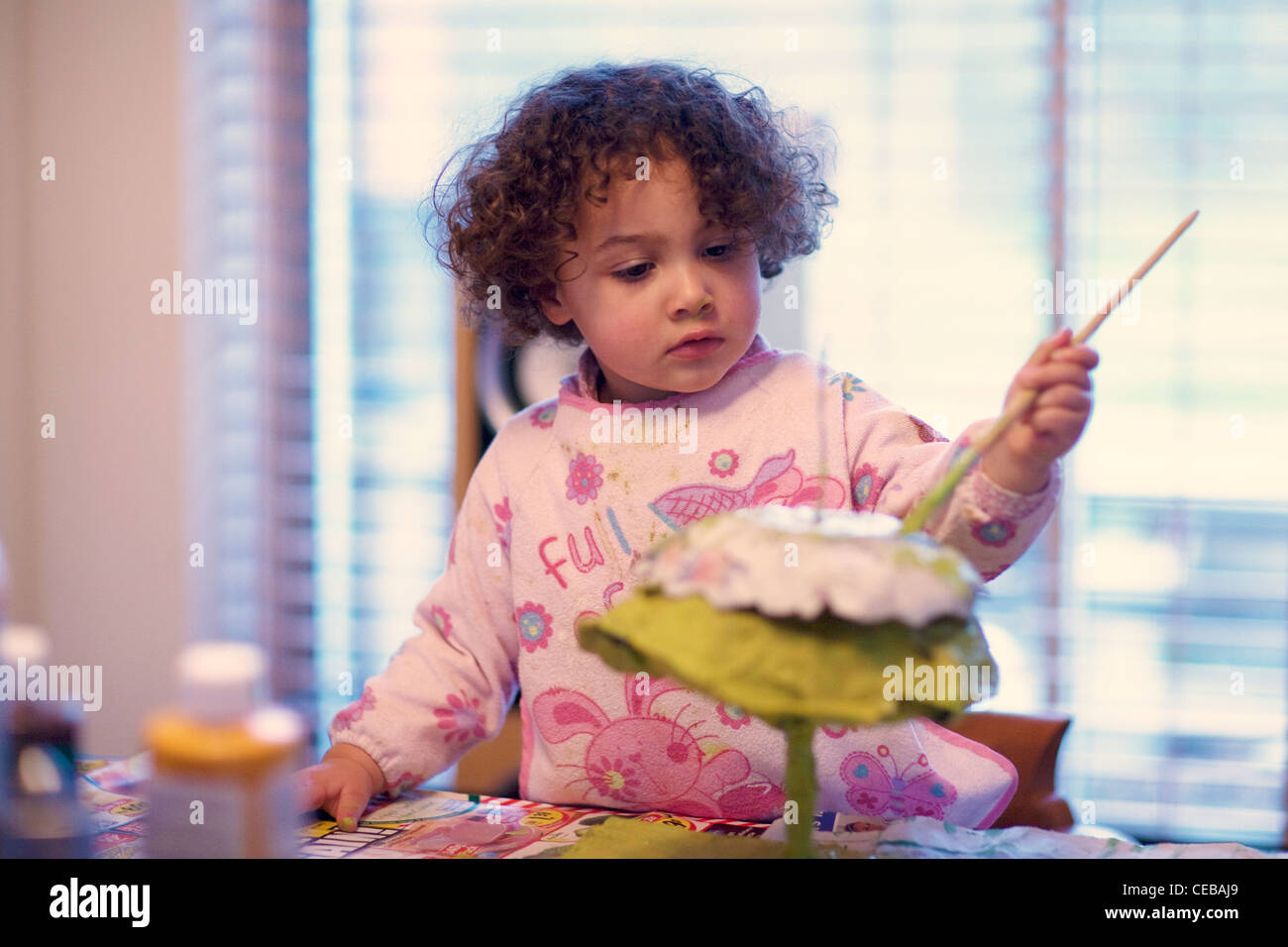Child girl toddler making model tree painting Stock Photo - Alamy