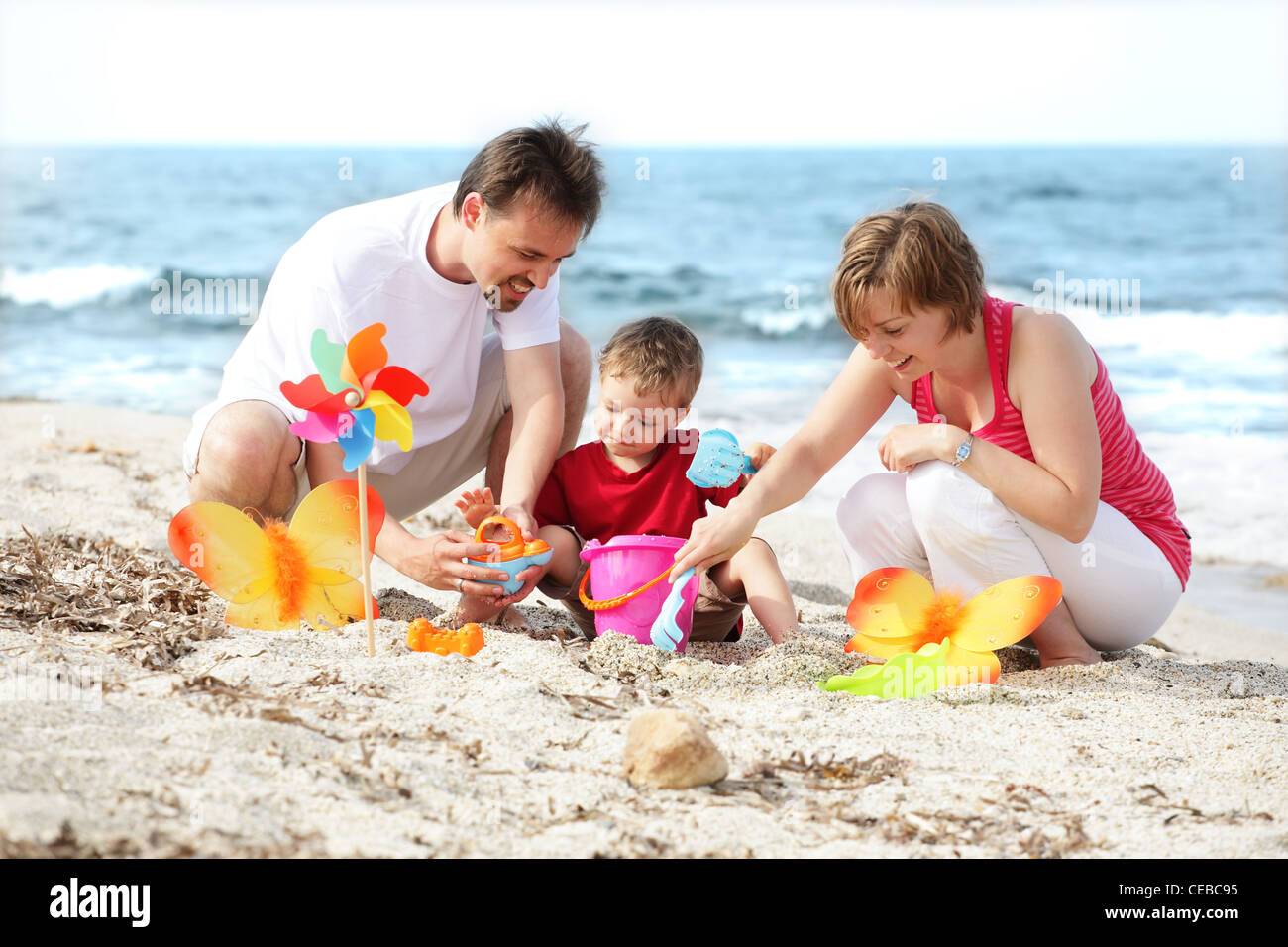Happy family on the beach Stock Photo - Alamy