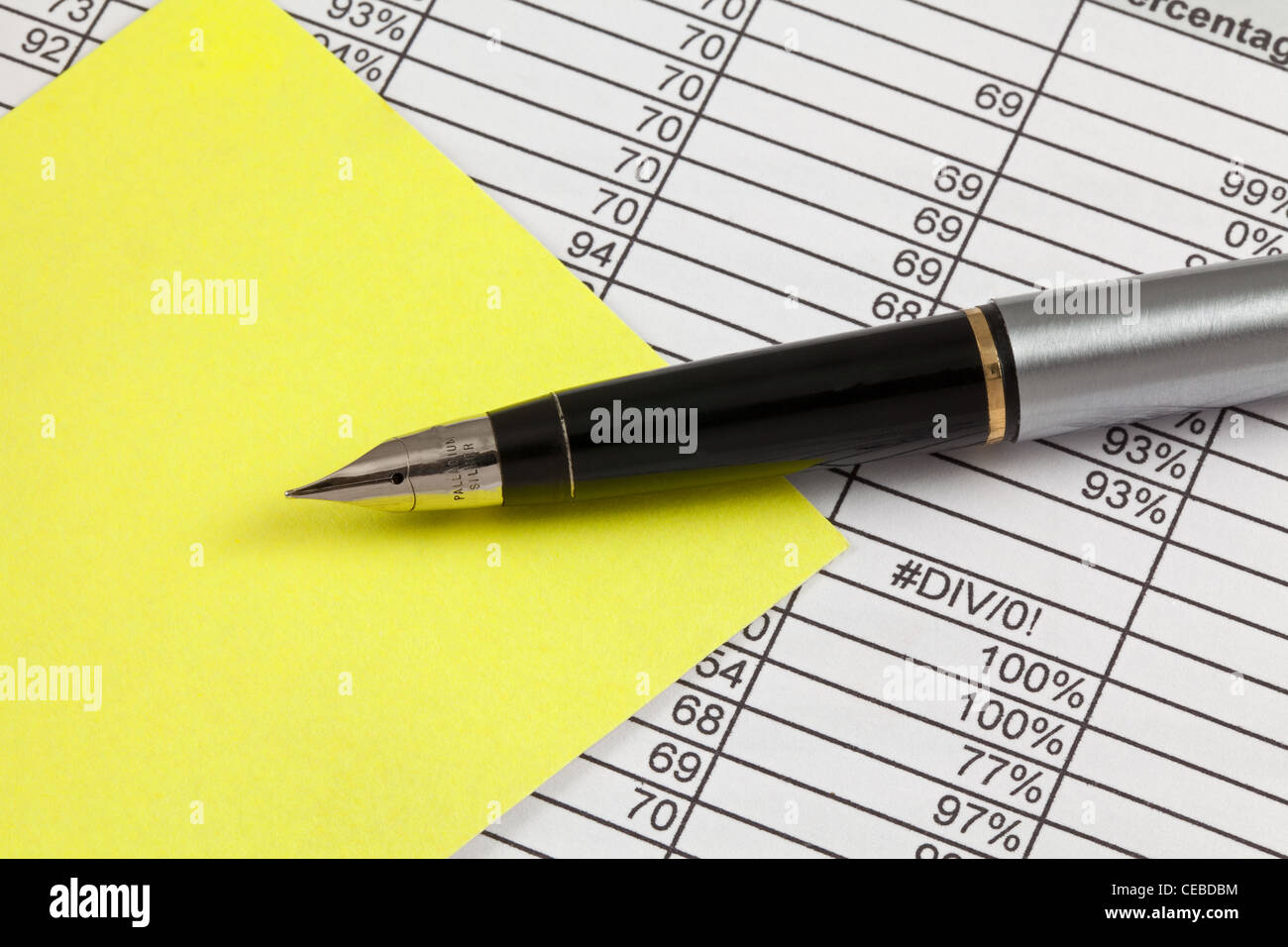 A pen and post it note on a spreadsheet with copy space Stock Photo - Alamy