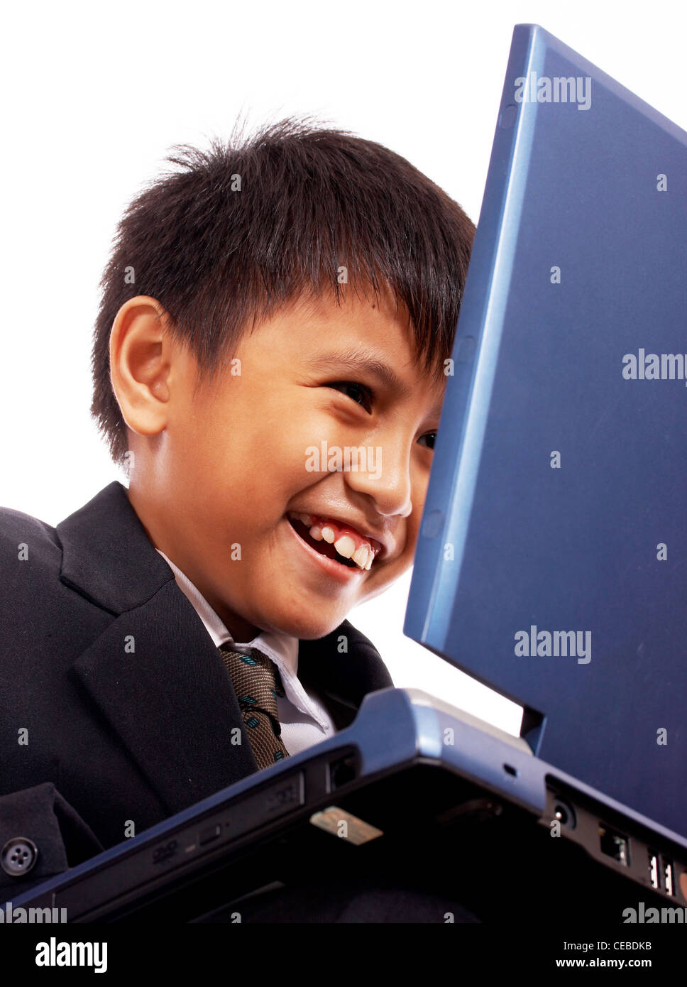 Boy Smiling And Having Fun Using The Internet Stock Photo - Alamy