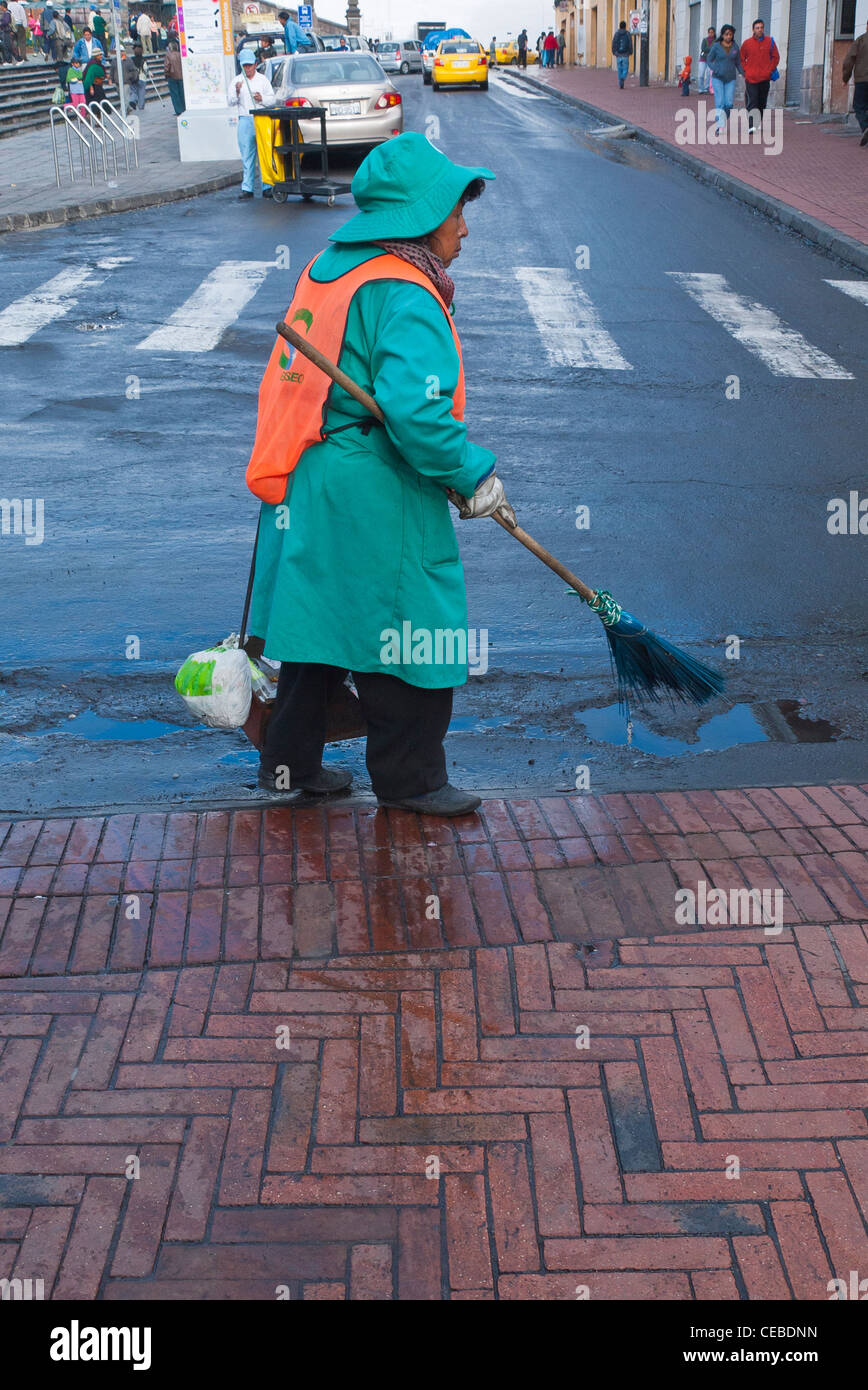 A woman street sweeper working with her broom on the streets of Quito ...