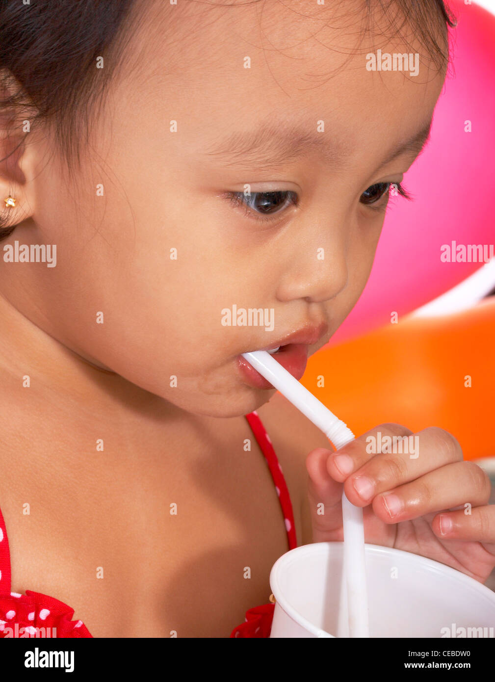 Kid Sipping A Drink At A Birthday Party Stock Photo - Alamy