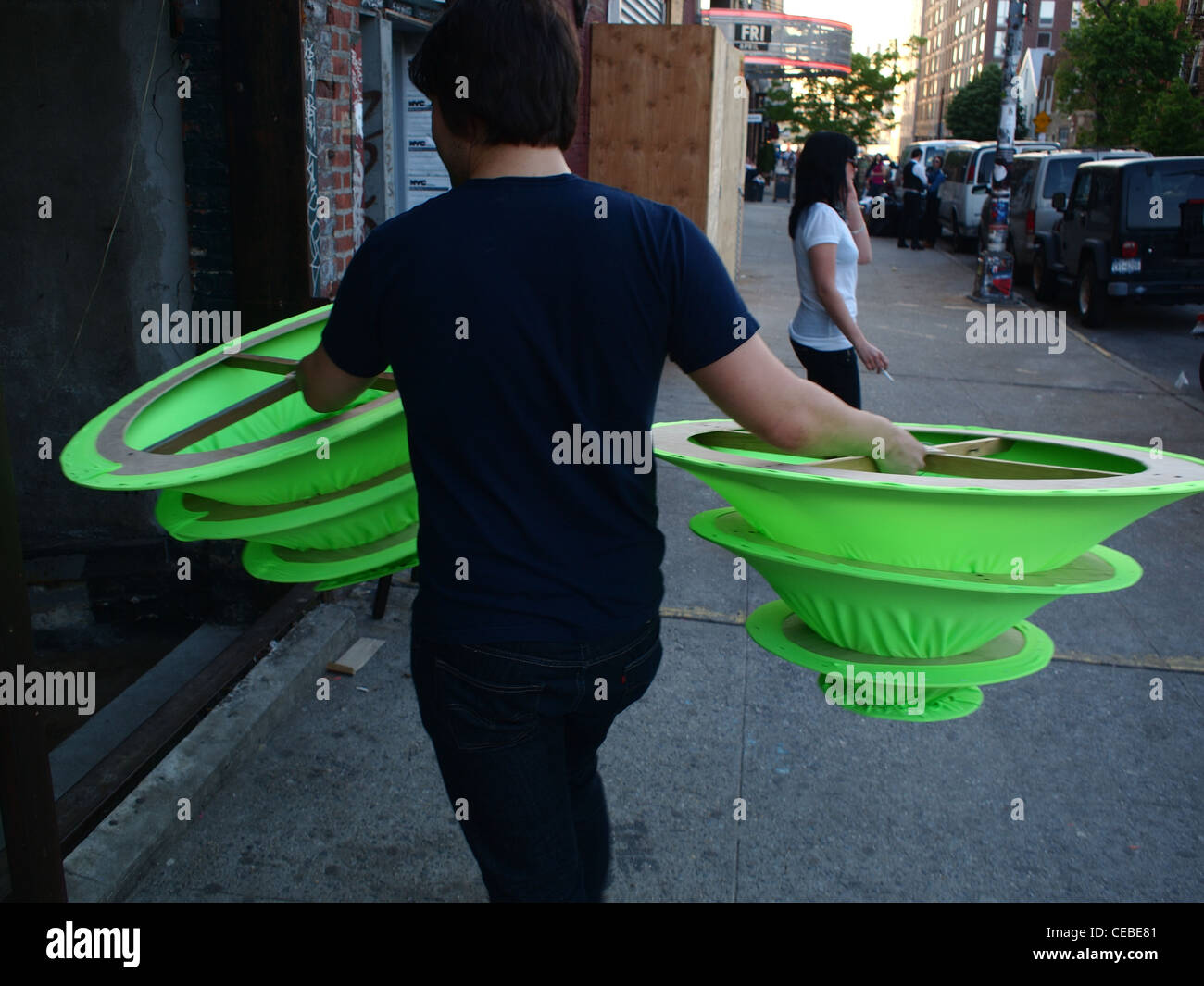 Man carrying green objects on street, Brooklyn, New York Stock Photo ...