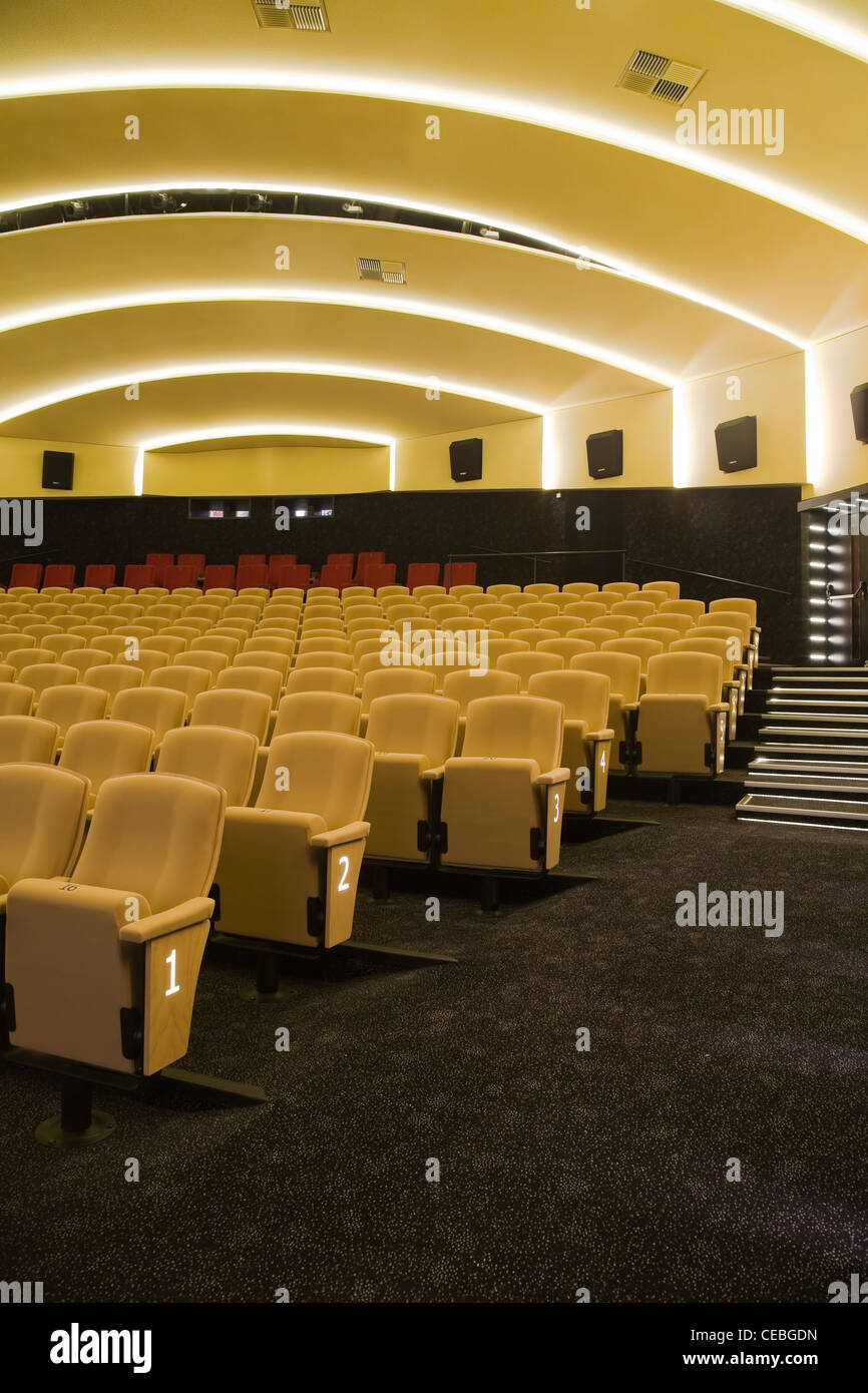 Empty cinema auditorium with line of chairs. Side view Stock Photo - Alamy