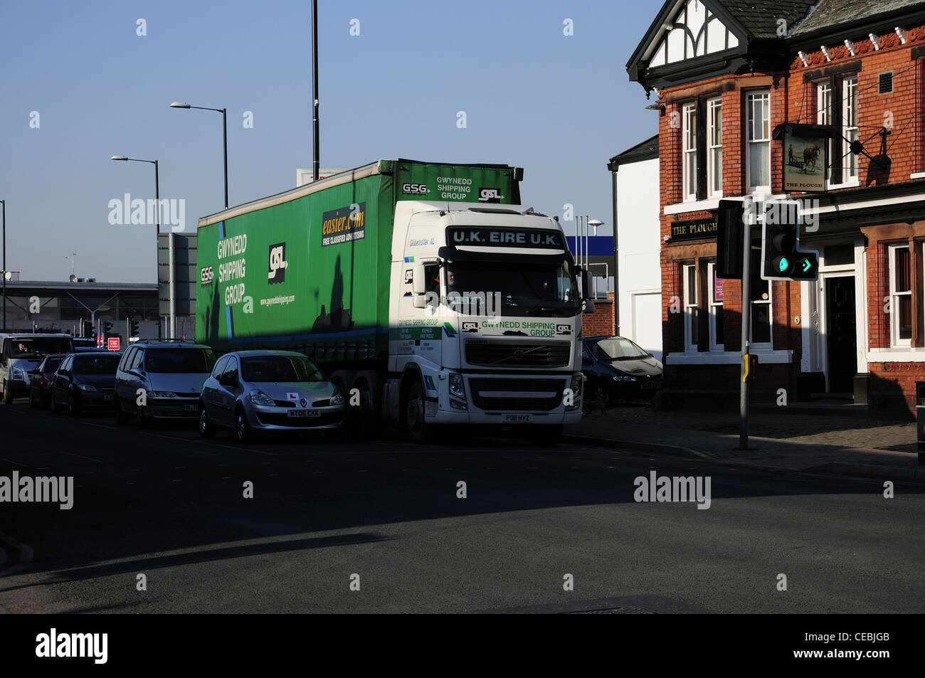Traffic on main road at light controlled junction Stock Photo - Alamy