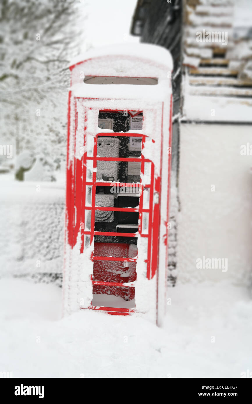 A British red phone box is covered in snow in the freezing British ...
